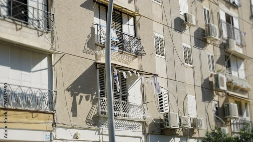Israeli flags and bunting flags hanging from balconies and windows on ...
