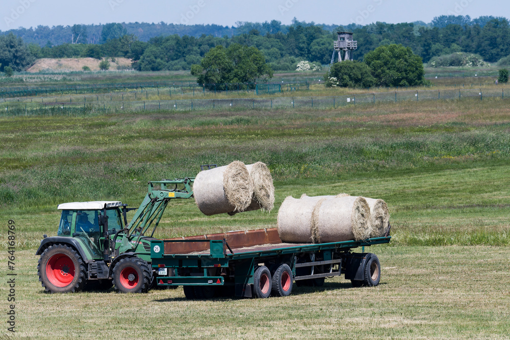 Bauer mit Traktor bei der Heuernte Stock Photo | Adobe Stock