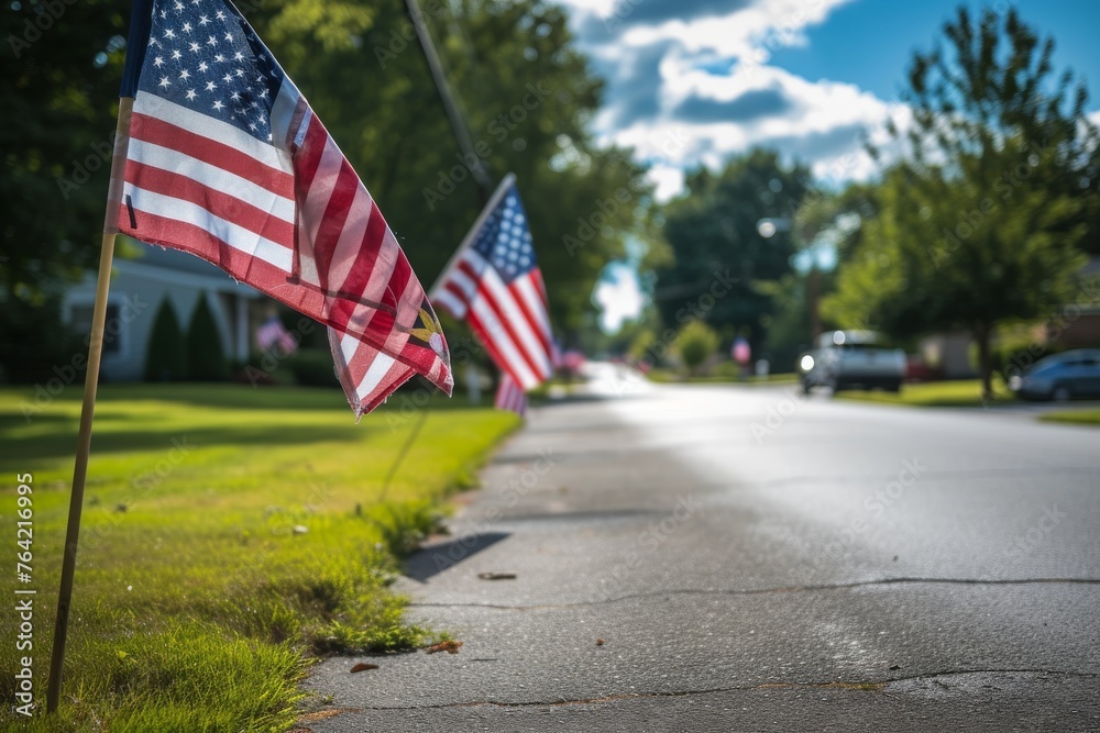 A line of American flags displayed along the roadside, evoking a sense ...