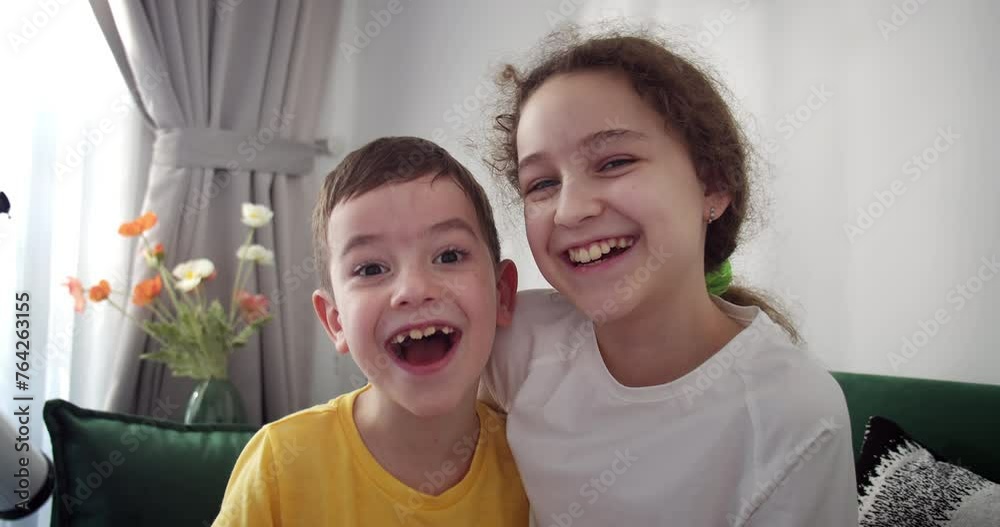 Pretty smiling child daughter embrace brother look at camera. Happy ...