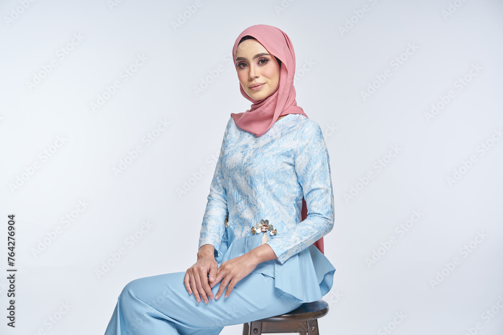 Beautiful female model wearing blue peplum dress with hijab, a modern ...