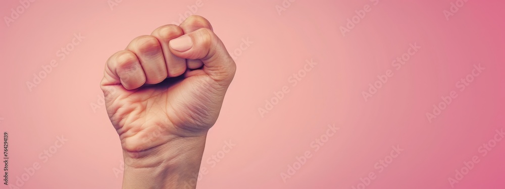 Female fist, gender female sign on pink background. Woman showing fist ...
