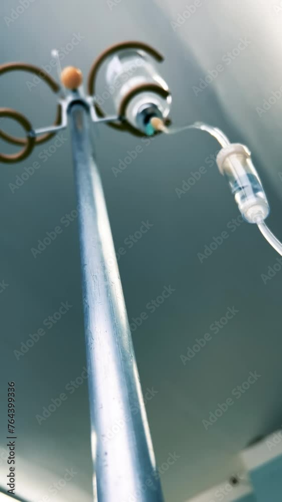 Medical infusion stand with a dropper bottle and a IV with a drip ...
