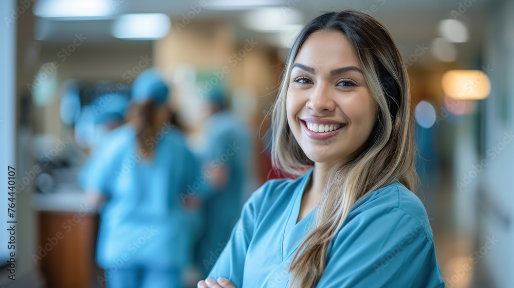 female hospital nurse looking at the camera at hospital ward with ...