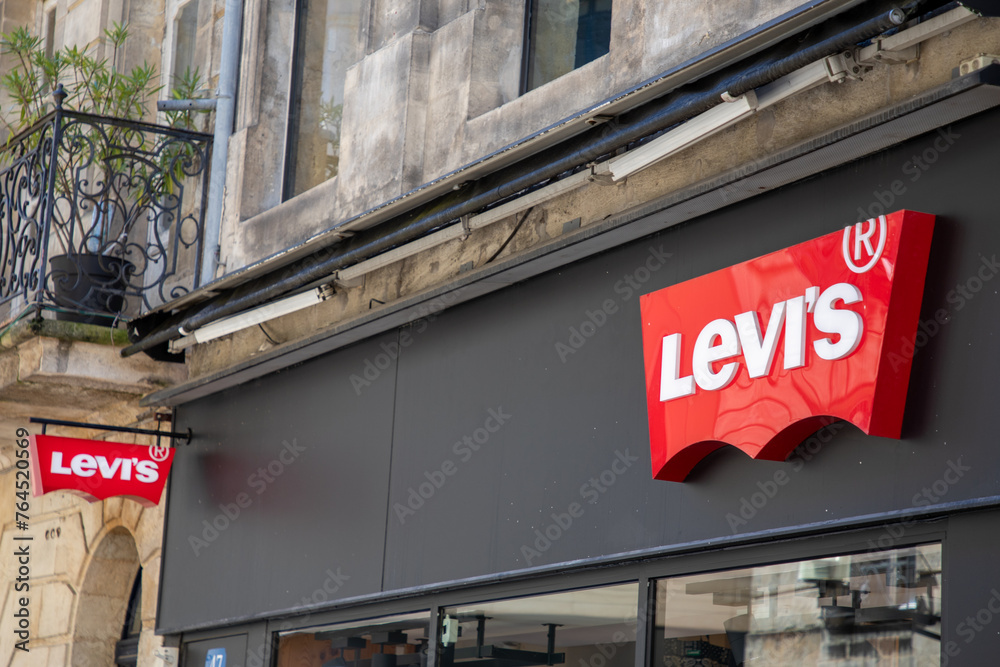 Levi's brand logo boutique and red sign text on facade entrance shop ...