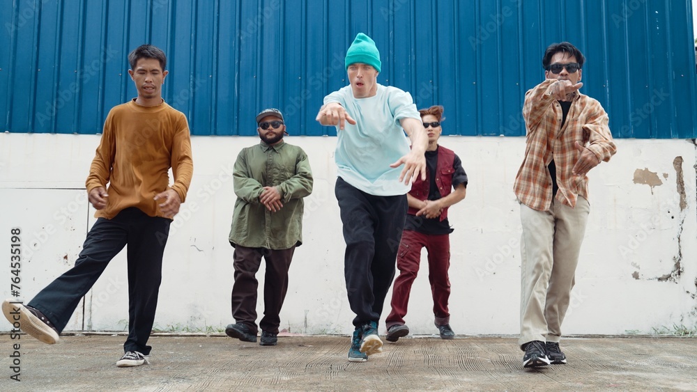 Group of hip hop choreographer dancing street dance together at wall ...