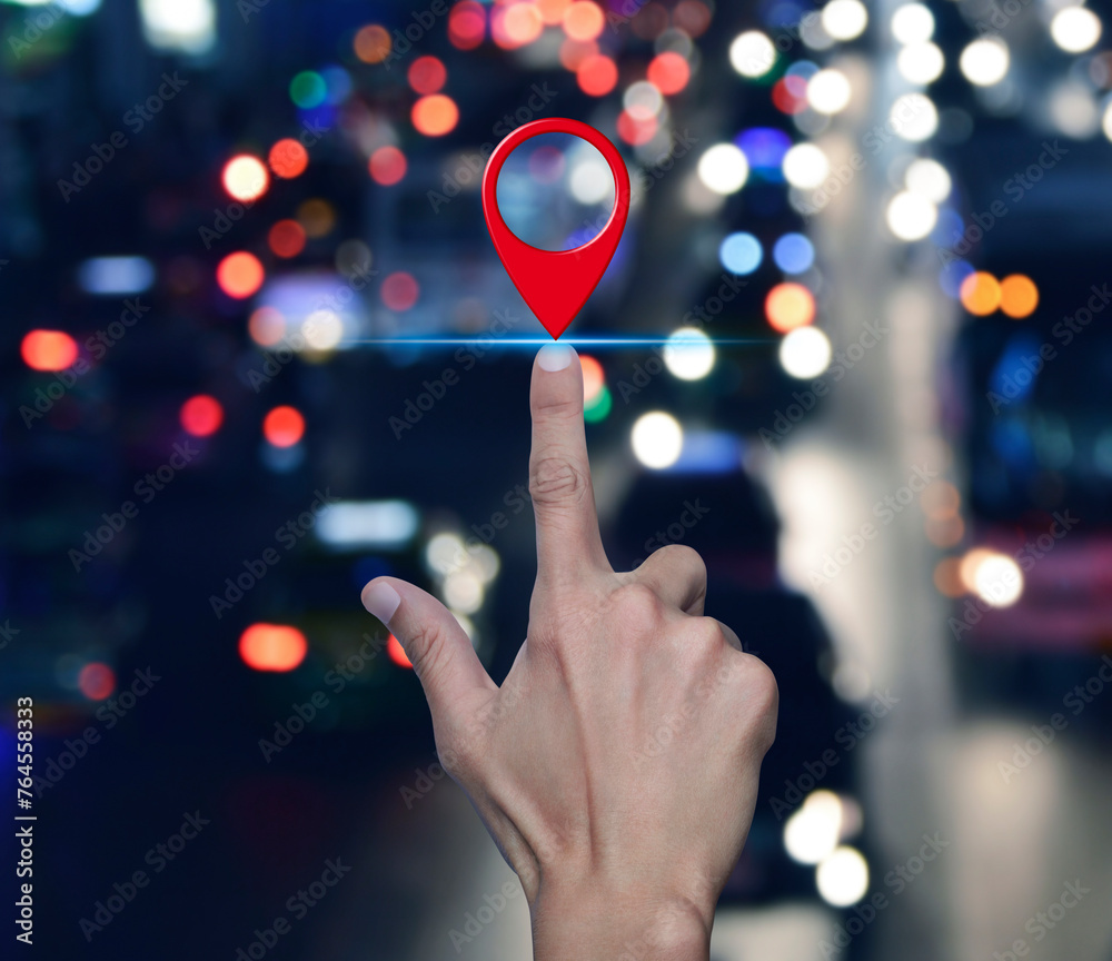 Hand pressing map pin point location button over blur colourful night ...