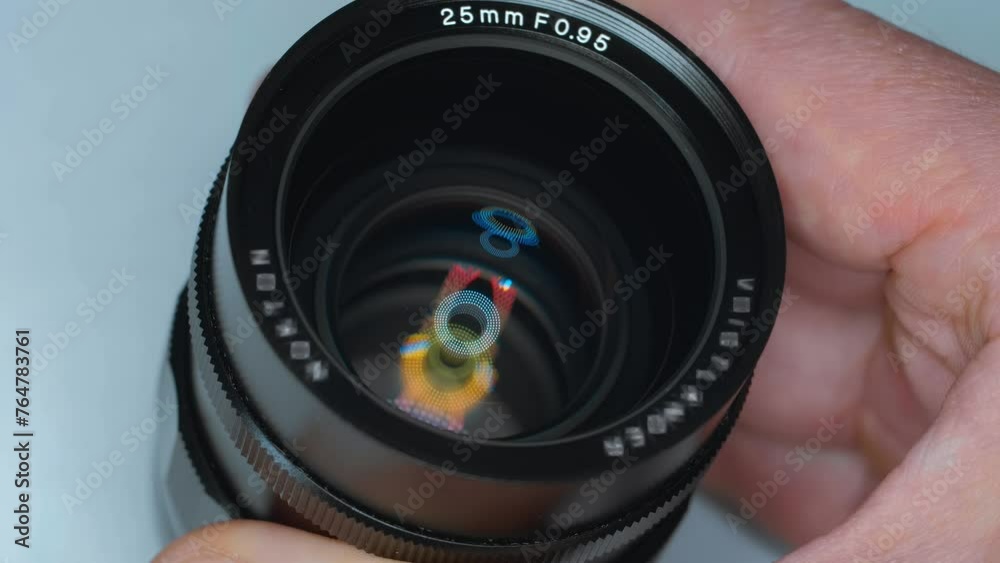 In the man’s hand is a rare and expensive professional lens with an ...