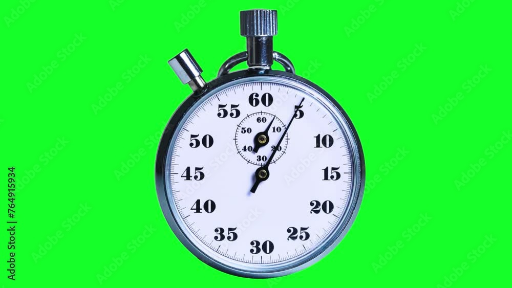 Analog metal stopwatch counts down a munute on a green background. Real ...