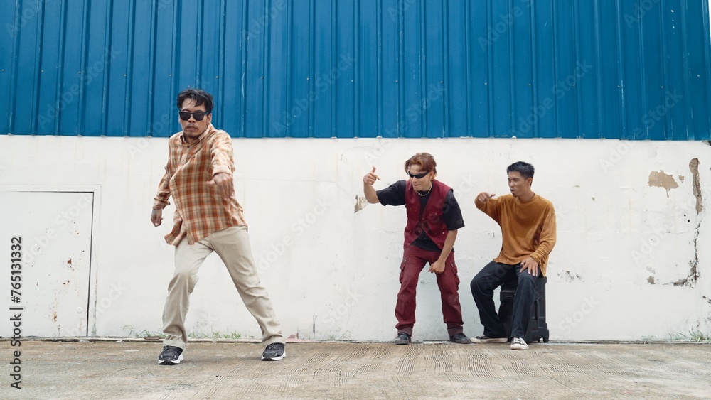 Young street dancer dancing in hip hop style with multicultural friends ...