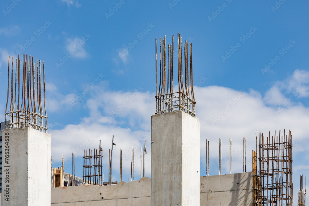 Poured concrete pillars in a high rise construction project showing ...
