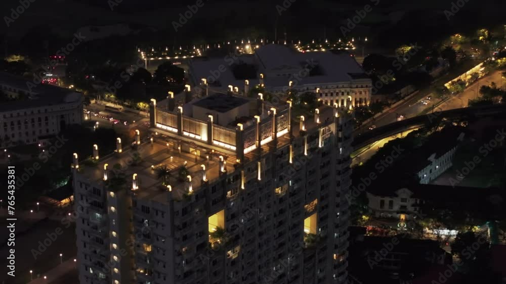 Fly around illuminated rooftop terrace of Torre de Manila. Modern high ...