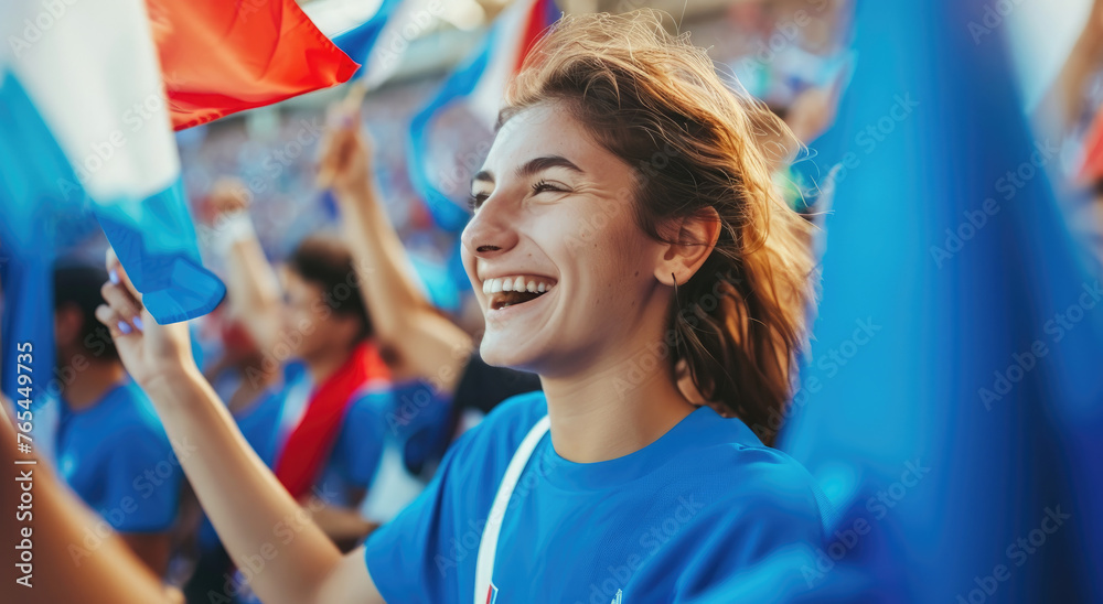 A French soccer fan wearing a blue jersey cheering with her friends in ...