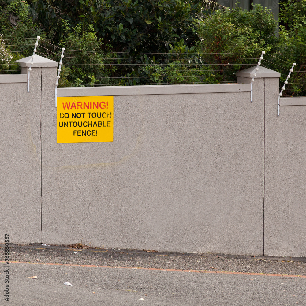 Electrical fence, warning and sign on wall of property for caution ...