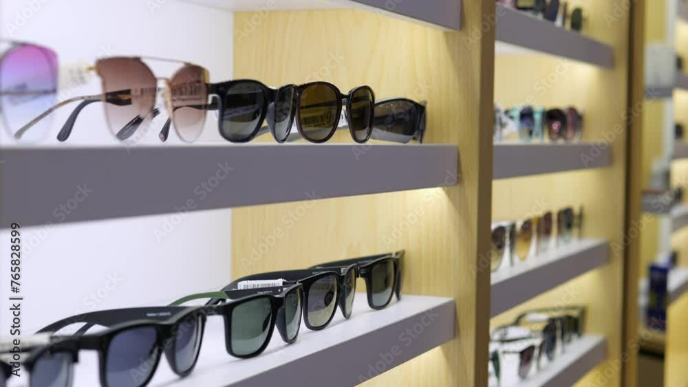 Boutique shelf wide range stylish sunglasses. Shelf with models in ...