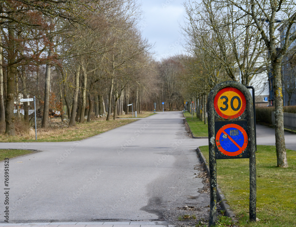 Road with speed limit sign of 30 km/h and parking forbidden sign Stock ...