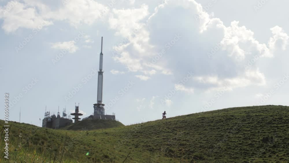 Vidéo Stock Shot of a station on the hill with two people passing by ...