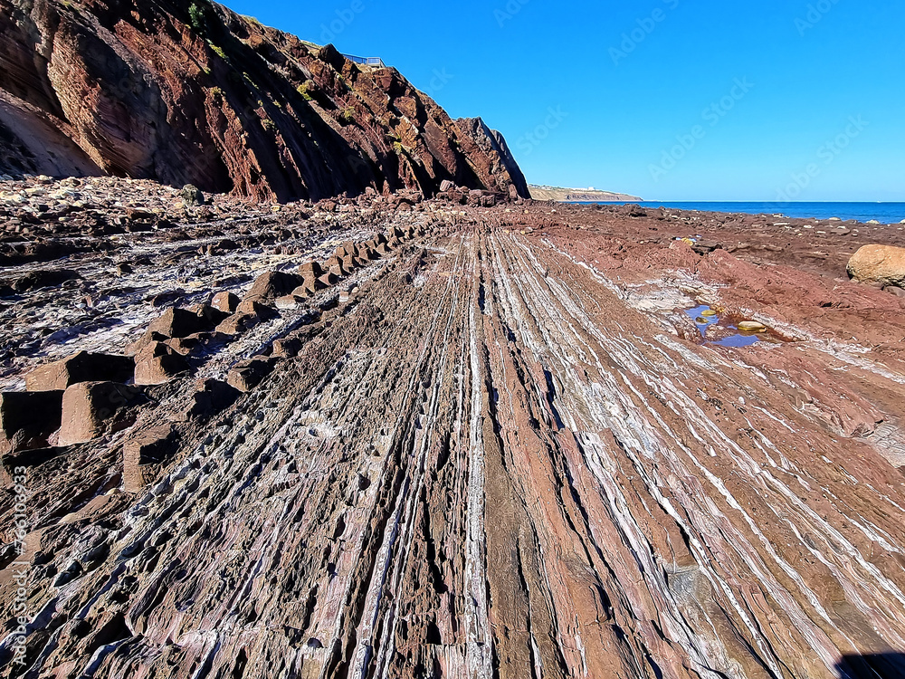 Unusual rock structure against the sea water background, coastline ...