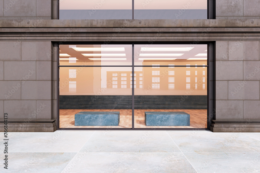A minimalist shopfront with large windows and two empty podiums for ...