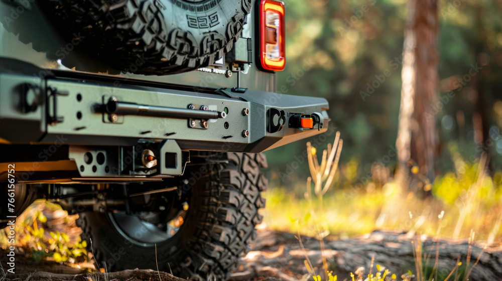 A reinforced steel rear bumper, with integrated steps and hitch ...
