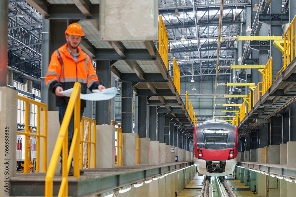 Electrical engineer railway in the maintenance station using blueprint ...