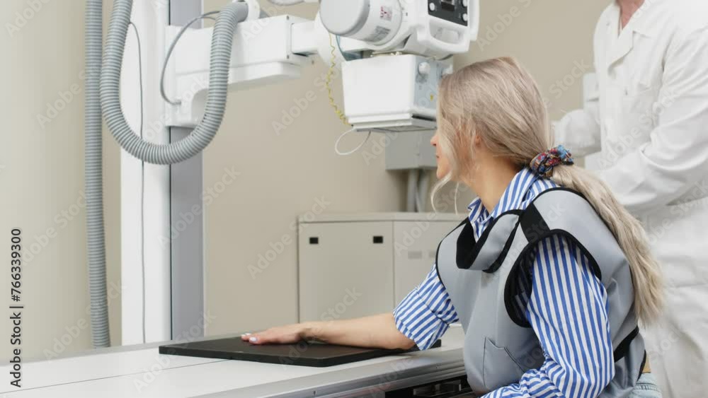 The doctor prepares the patient for an X-ray of the arm. Preparing for ...