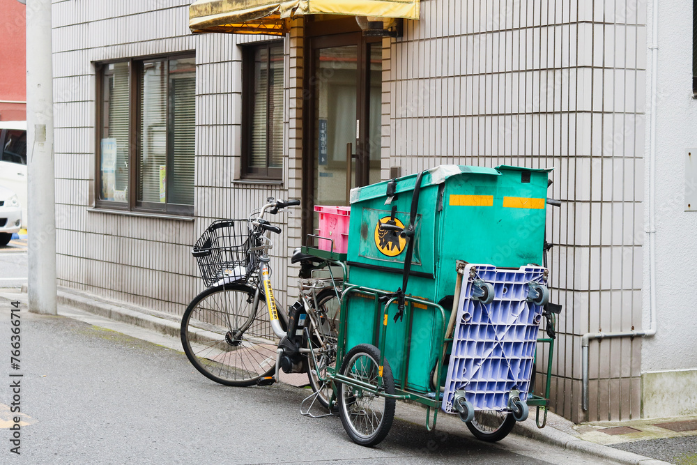 TOKYO, JAPAN - June 16, 2022: A Yamato (Kuroneko) delivery company cart ...