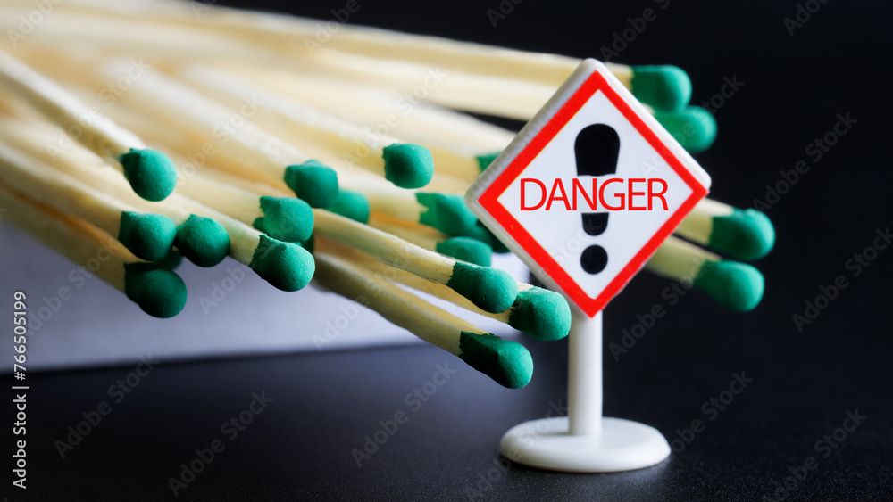 An open matchbox next to a Danger warning sign. Concept for teaching ...