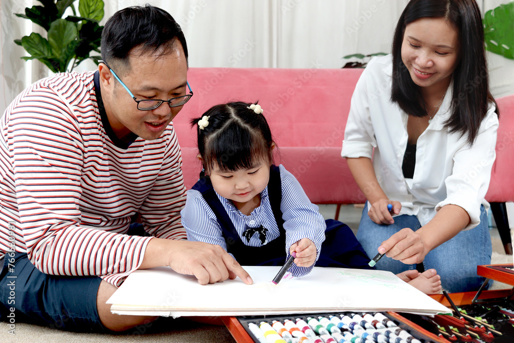 Happy Asian family. Chubby little girl daughter drawing together with ...