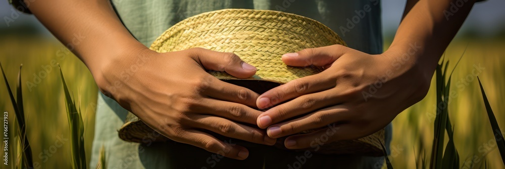 The hands of A Portrait of a farmer wearing a wicker hat outdoors ...