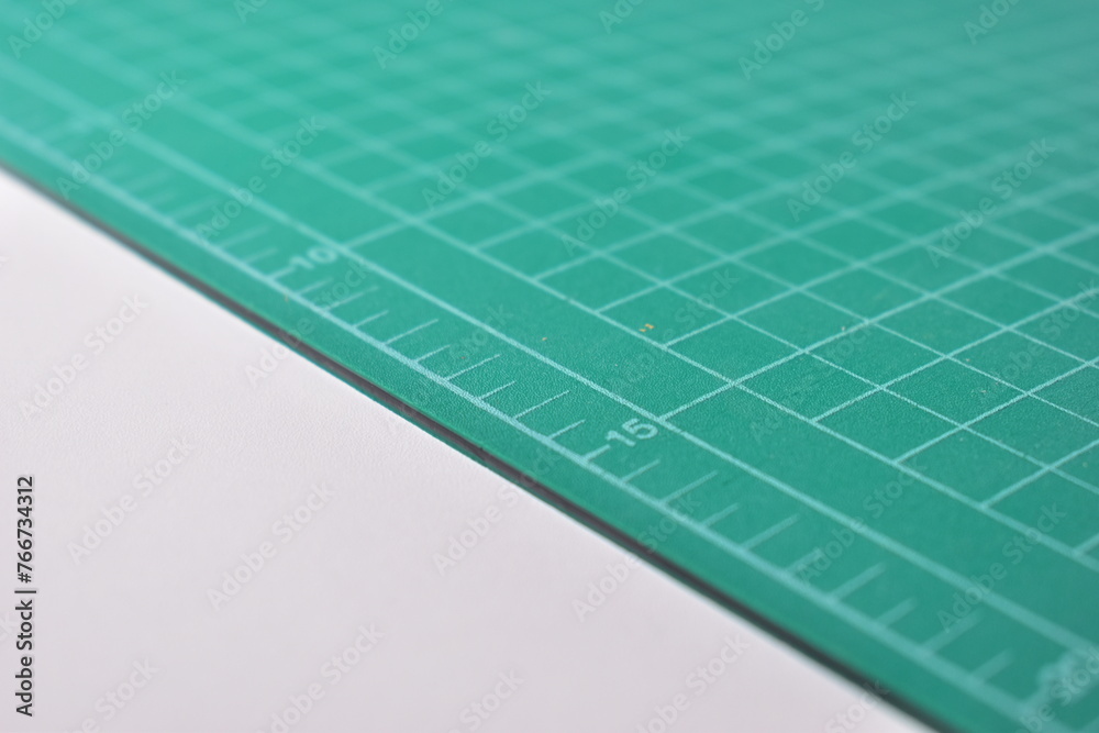 green cutting mat board on white background with line and scale measure ...