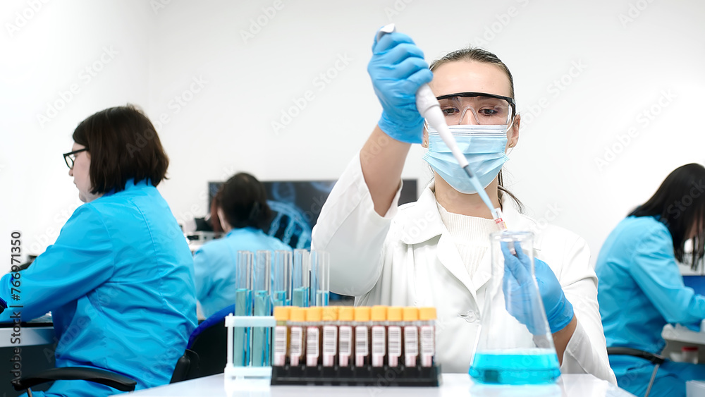 Portrait of a beautiful female scientist using a micropipette for ...