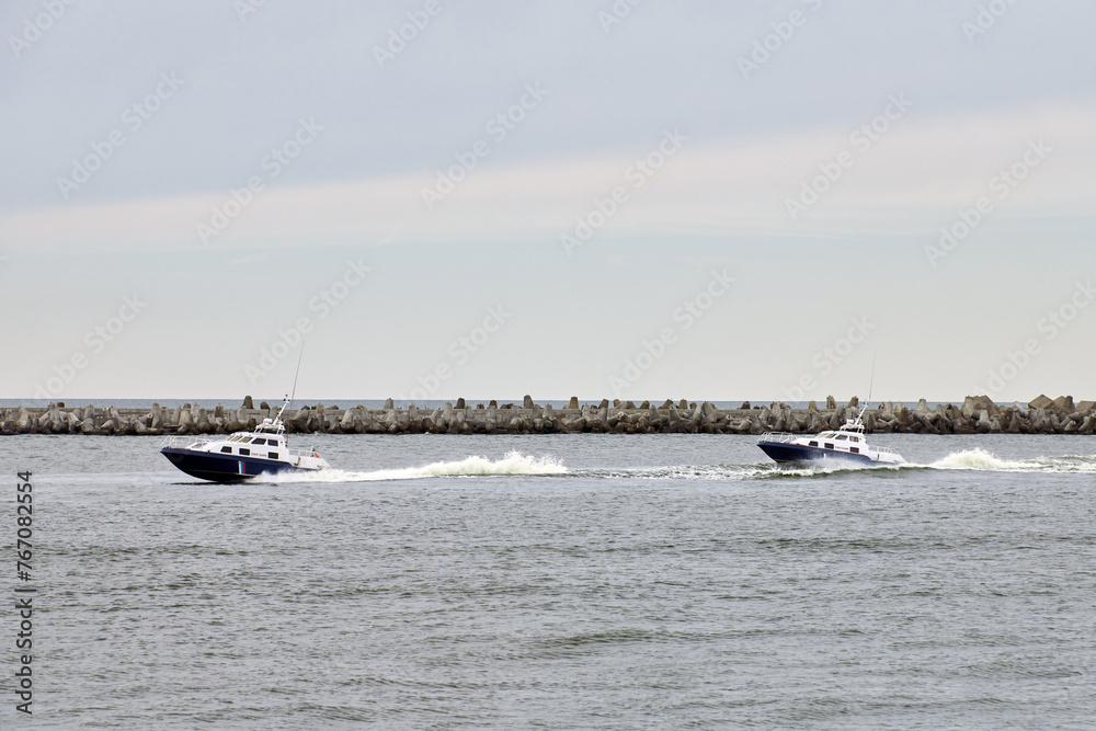 Two coast guard boats sails along seaside for safeguarding coastal ...