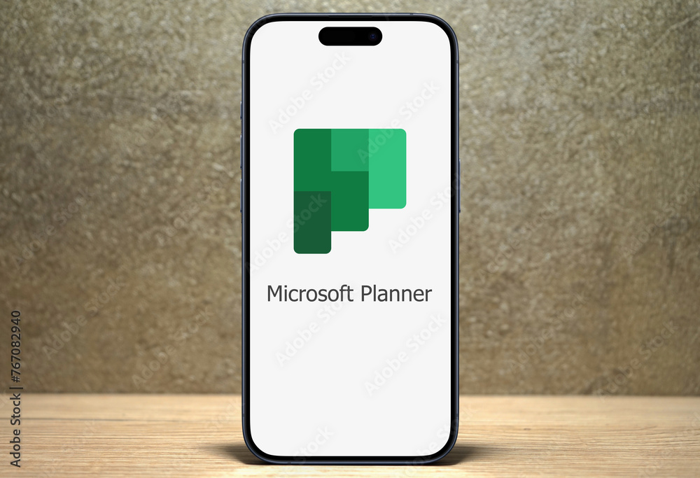 Microsoft Planner logo is displayed on a modern smartphone standing on ...