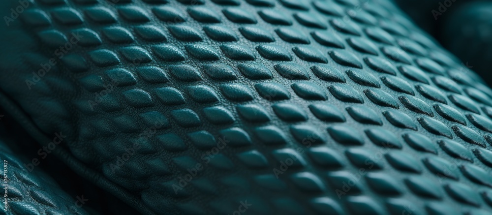 A closeup of an electric blue rubber mat with a mesh grille pattern and ...