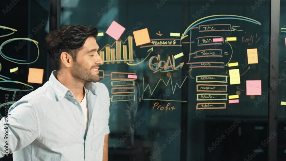 Smart smiling businessman finish writing marketing idea and posing at ...