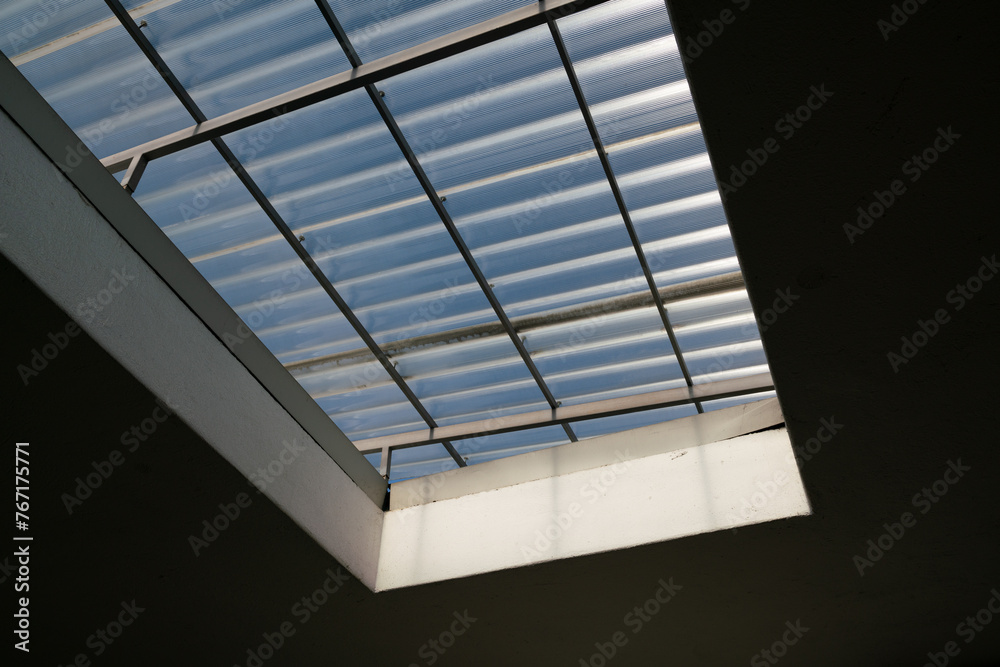 skylight, on a flat roof, and a structure that protects from rain but ...