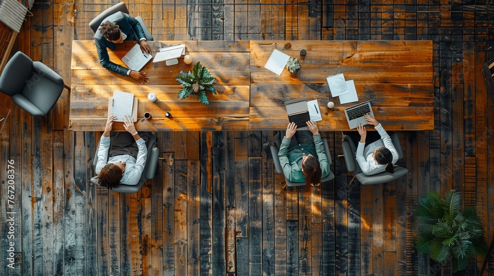 Team collaboratively working around a modern office table. Capturing ...