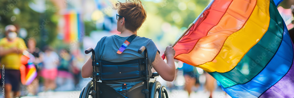 Back view disabled gay man in wheelchair with rainbow LGBTQ+ flag ...