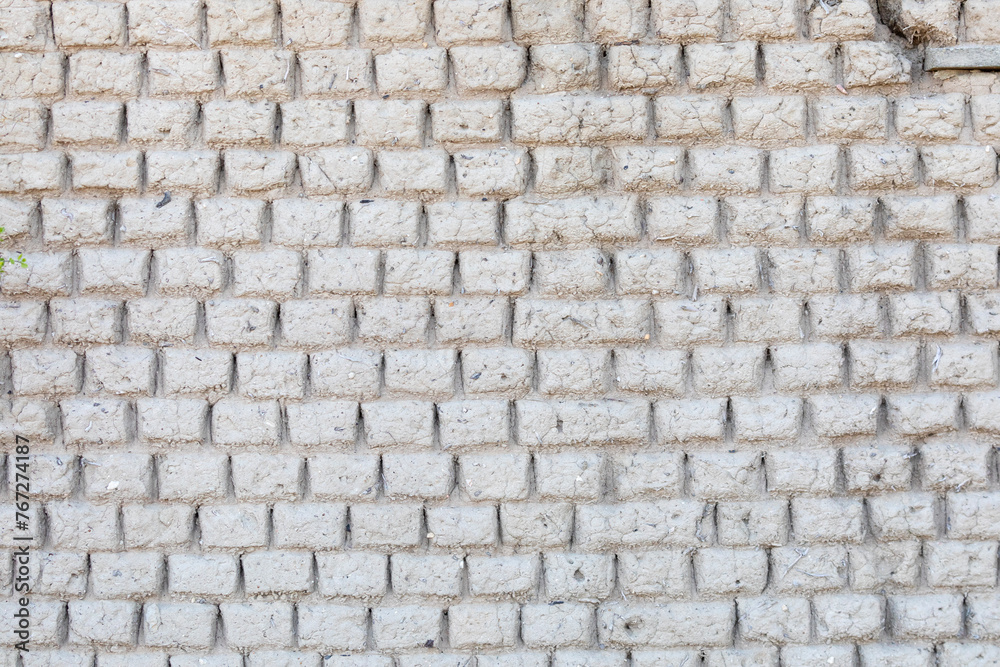 Wall of rustic coastal cottage built of hand-made clay or mud bricks ...