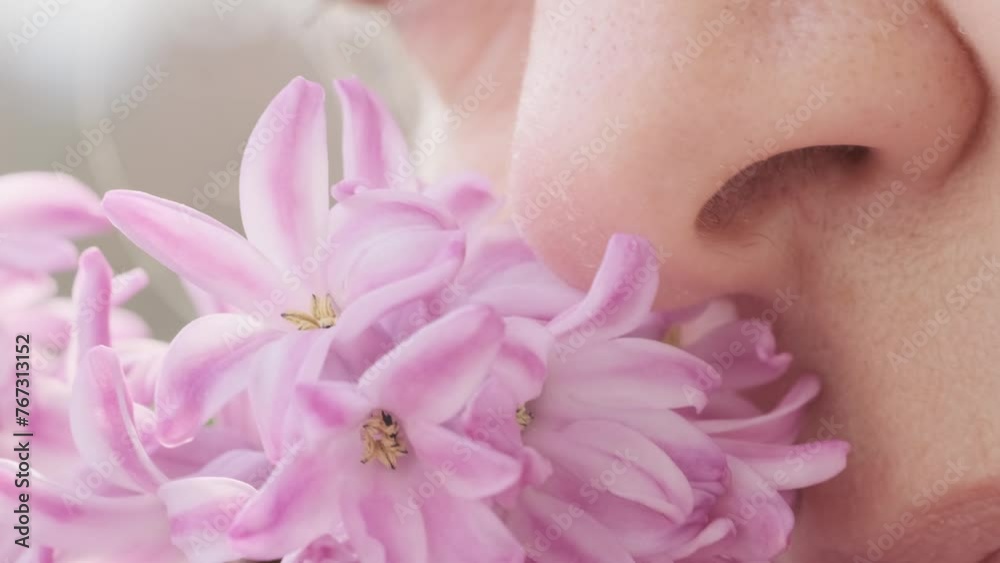 close-up Female face lights up with delight savors sweet scent hyacinth ...