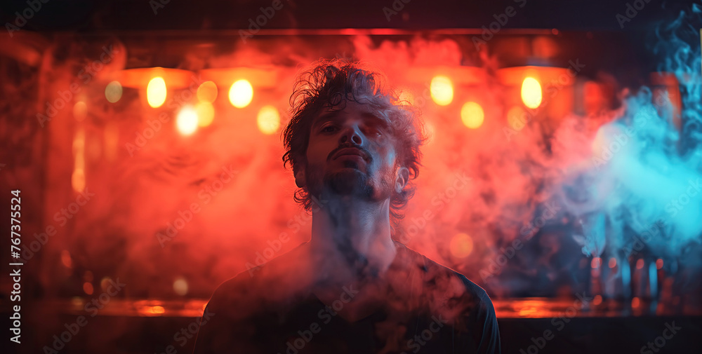 portrait of man smoker smoking a smoky hookah in shisha bar with neon ...