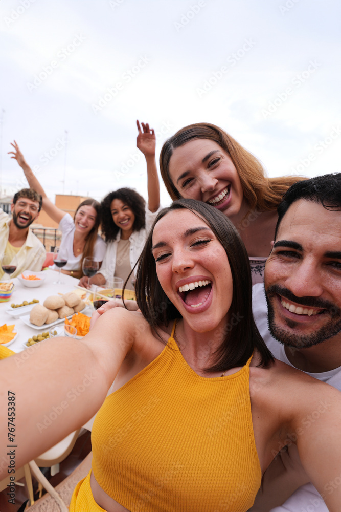 Vertical. Excited young pretty woman taking group selfie with joyful ...