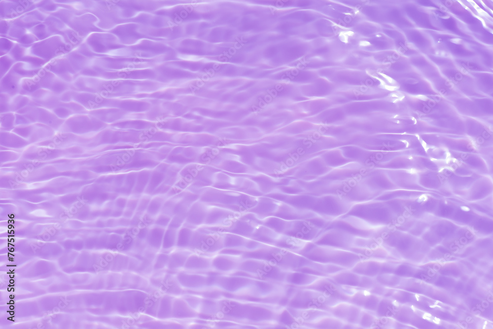 Purple water bubbles on the surface ripples. Defocus blurred ...