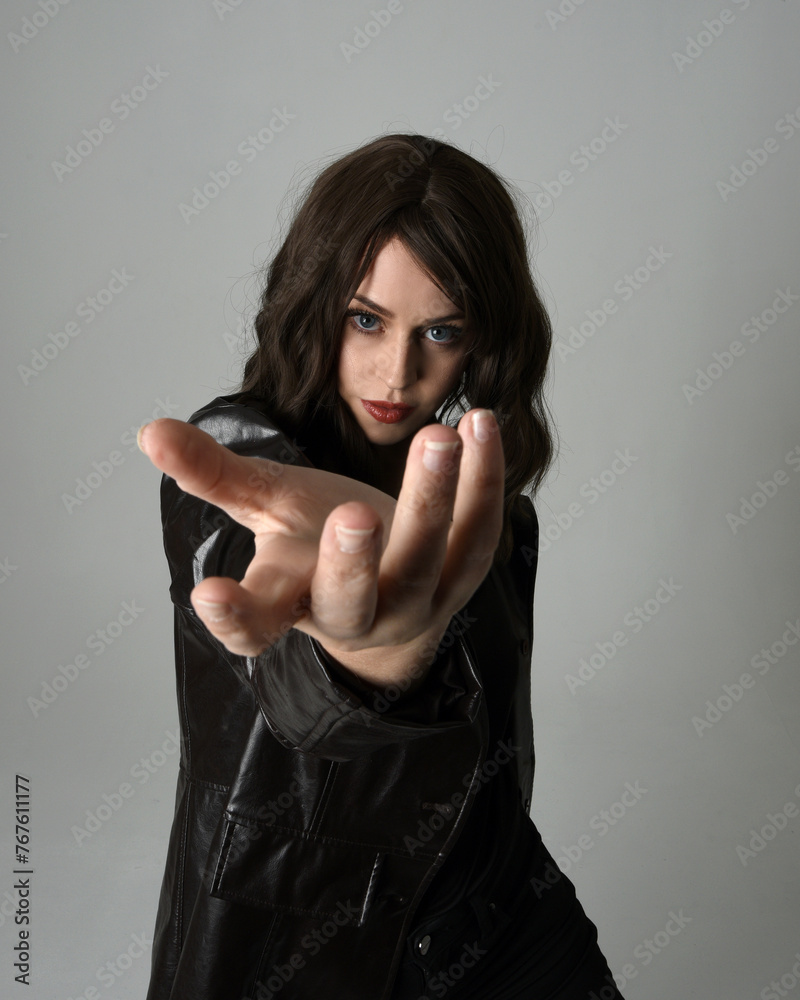 close up portrait of beautiful brunette woman wearing long black ...