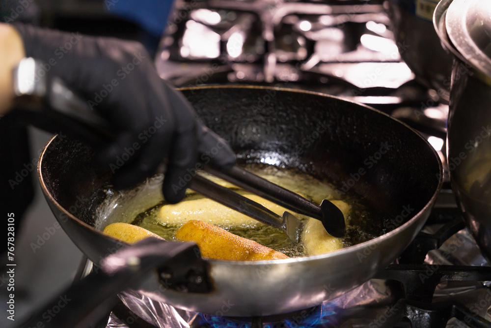 Chvishtari, Georgian cornbreads with cheese inside, are fried in a ...