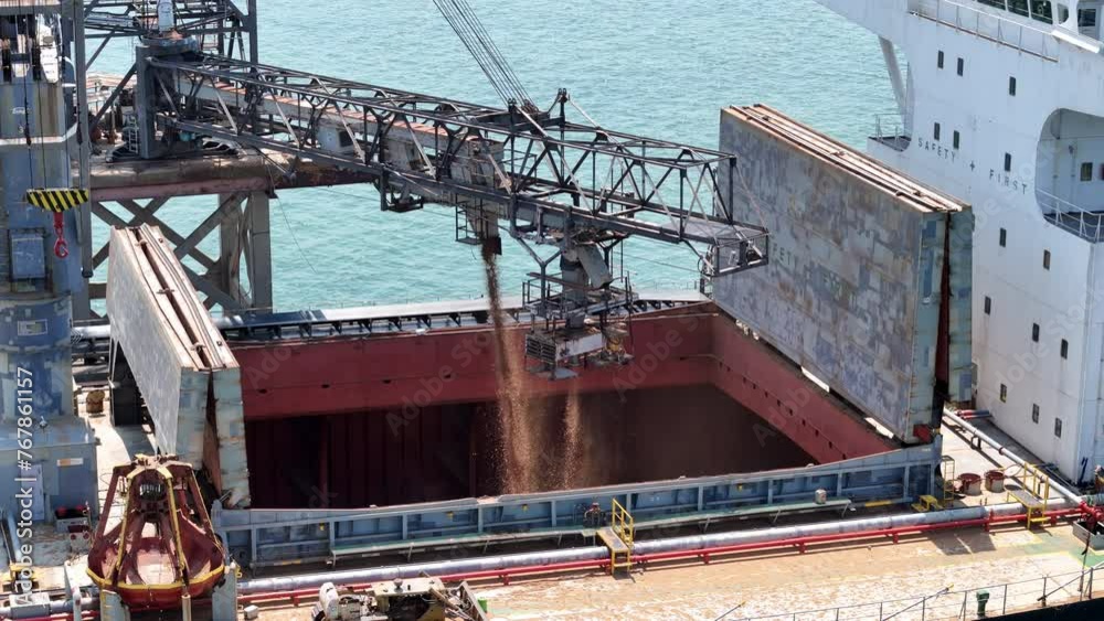 Aerial top view wood chips load chip from silo to cargo ship vessel ...