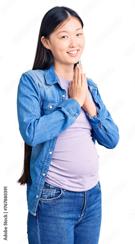 Young beautiful chinese woman pregnant expecting baby praying with ...
