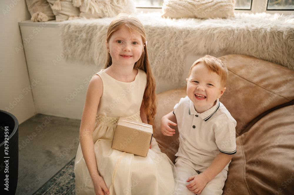 Happy and surprised boy and girl open birthday present box. Cheerful ...