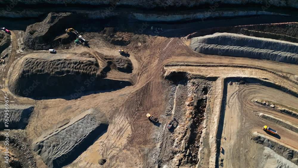 Drone footage over an Excavator working on an open pit mine, quarry ...
